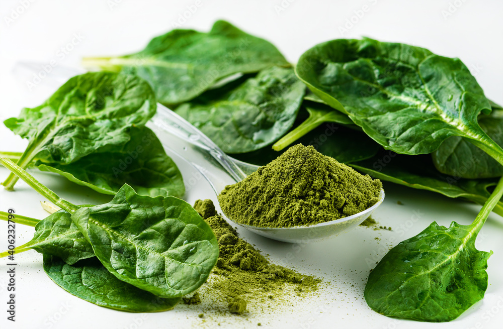 dry spinach powder on white background. Green Powder. Could be any ...