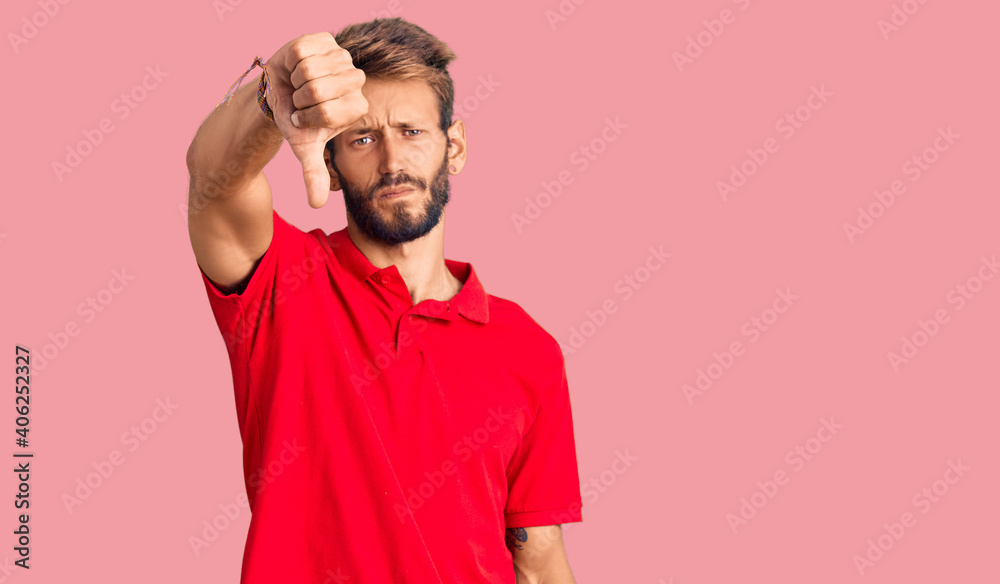 Handsome blond man with beard wearing casual clothes looking unhappy ...