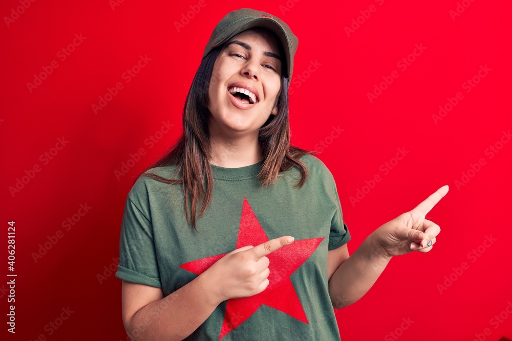 Young beautiful brunette woman wearing cap and t-shirt with red star ...