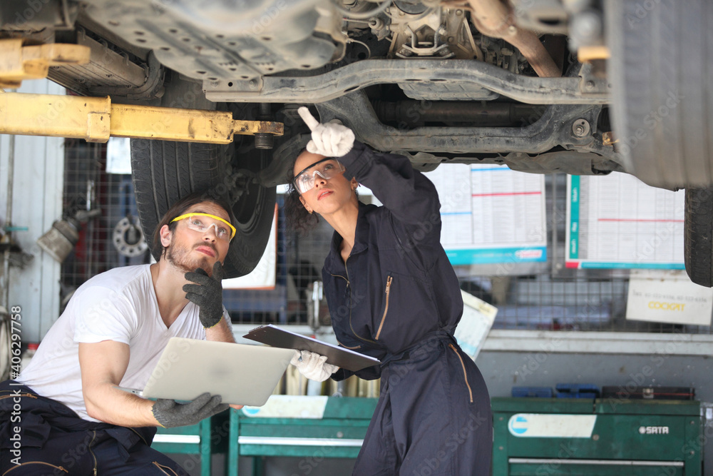 car mechanic use notebook computers to check engine and service ...
