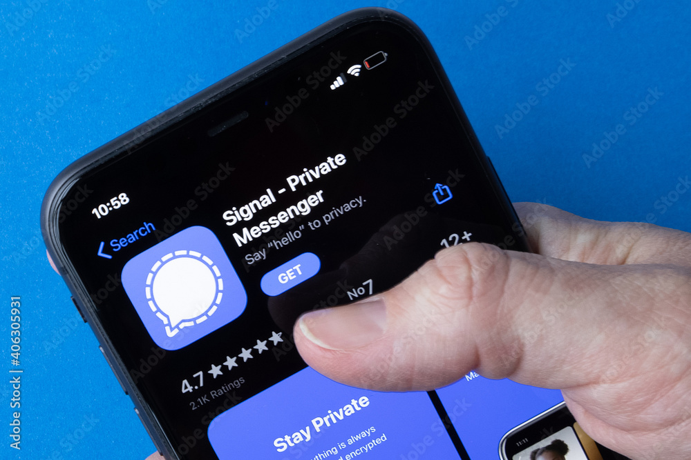 iPhone 11 on blue background with new messenger app Signal logo and ...