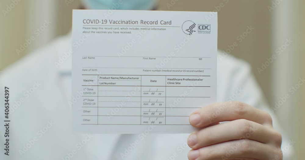Medical healthcare worker holding vaccination record card, risk free ...