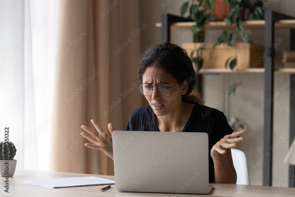 Unhappy young woman look at computer screen frustrated by gadget ...