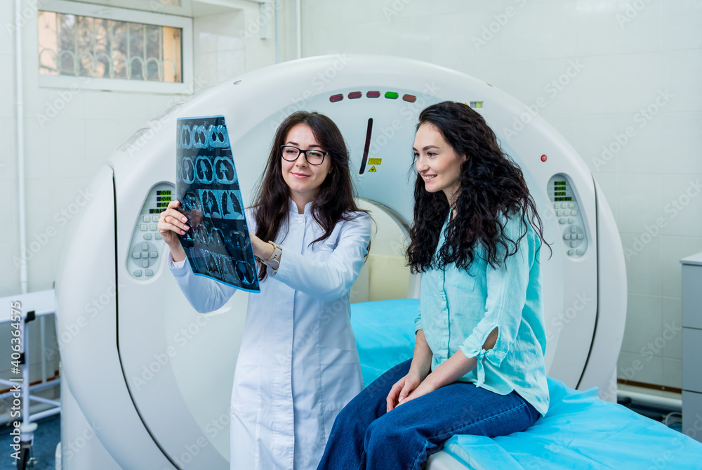 Radiologist with a female patient examining a CT scan Stock Photo ...