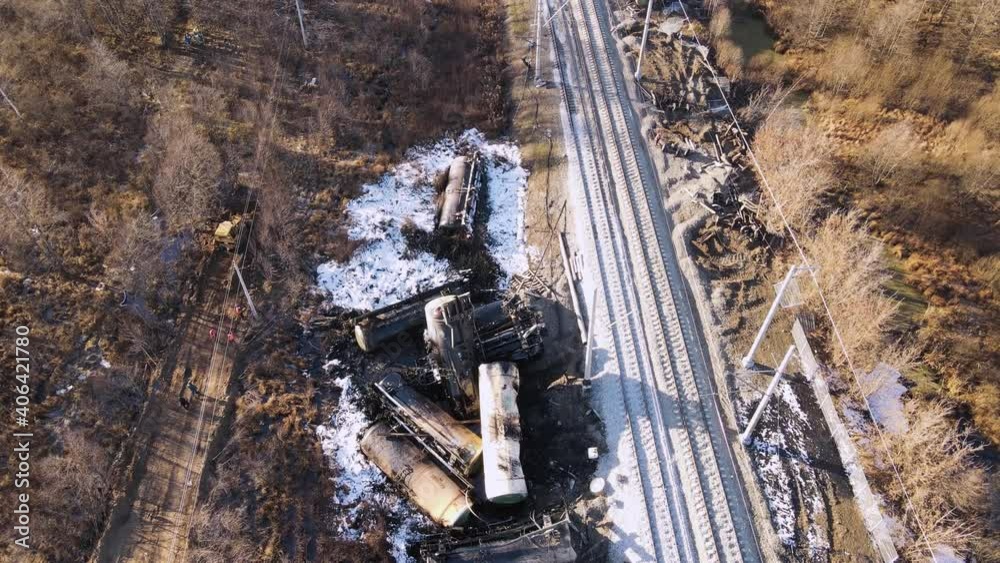 A train wreck on a railroad, scattered cisterns from collisions and ...
