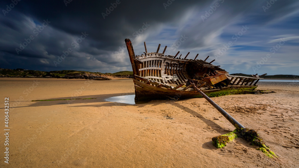 An old shipwreck boat abandoned stand on beach or Shipwrecked off the ...