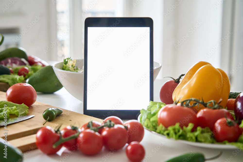 Digital tablet computer with mockup white screen on vegetarian healthy ...
