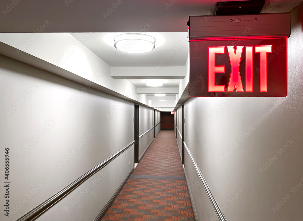 Exit sign in a corridor Stock Photo | Adobe Stock
