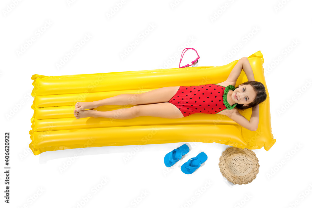 Cute little girl lying on inflatable mattress against white background ...