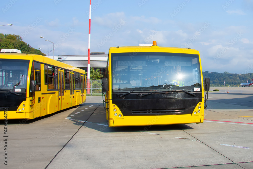 Shuttle yellow buses to transport passengers from the terminal building ...