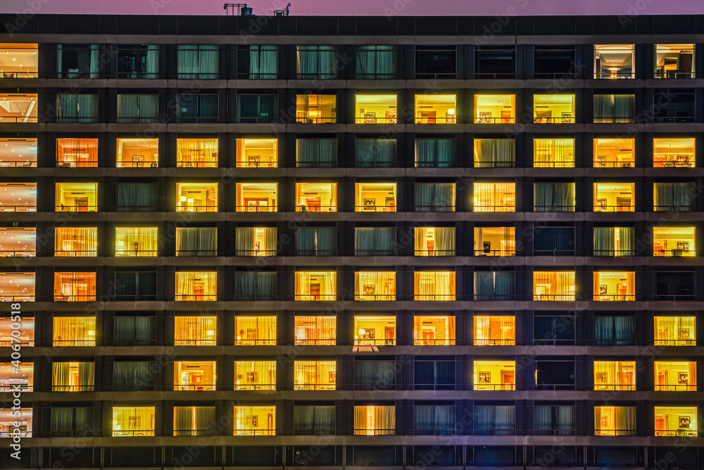 Poster Building facade shows a windows and rooms pattern at night ...
