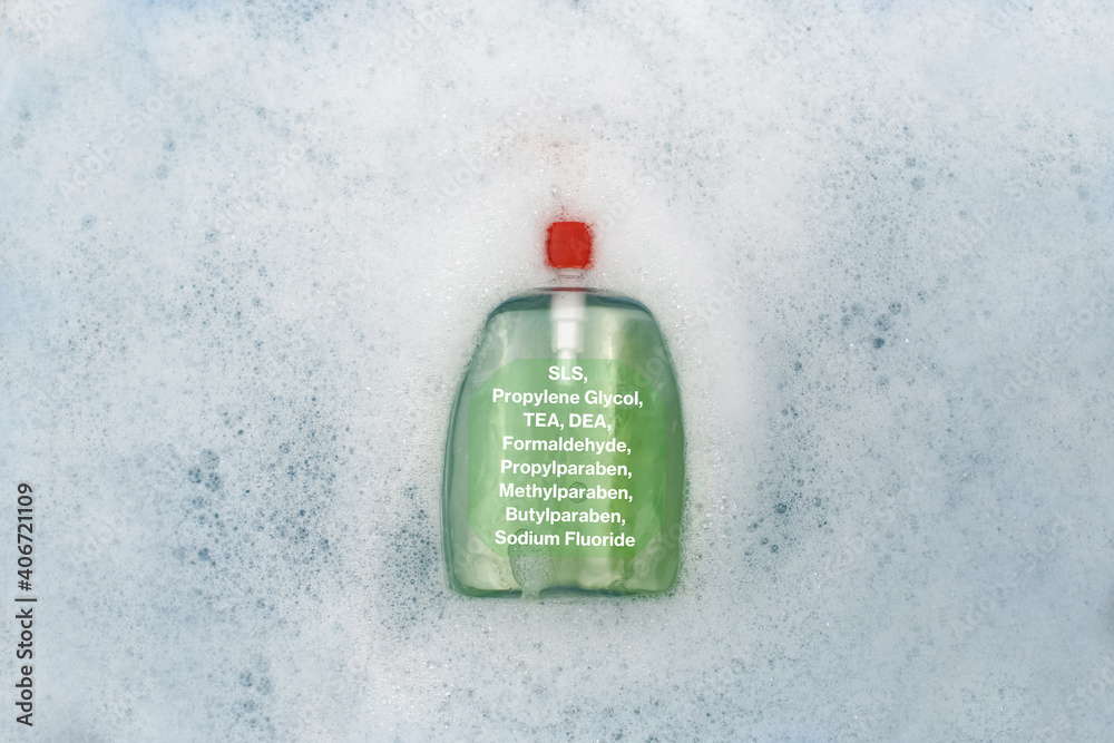 A bottle of Liquid soap floating in soapy water. Harmful composition of ...