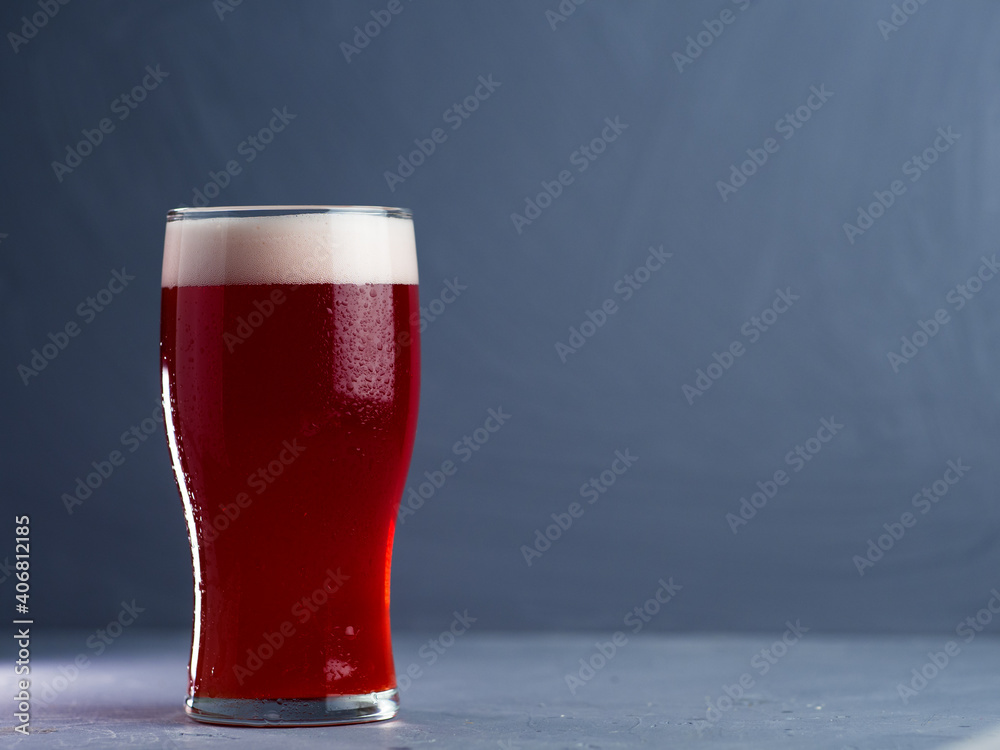 Foto de glass of red beer ale on a concrete gray table and copy space ...