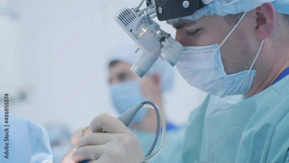 Operation of removing tonsils under deep anesthesia, surgeon uses ...