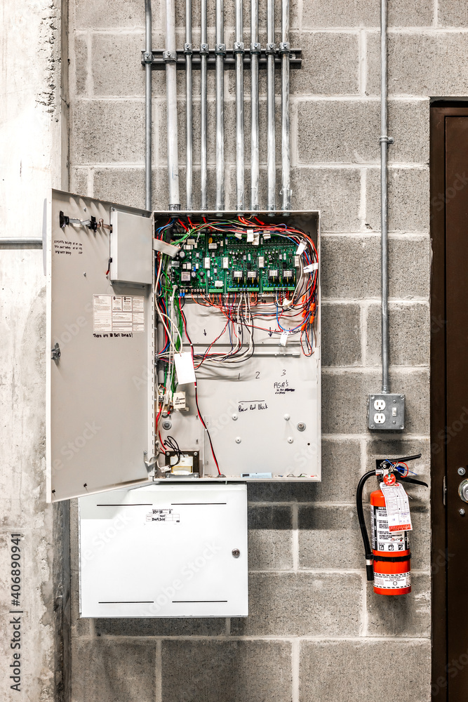 Open fire alarm cabinet with visible circuit board and wiring. Yearly ...