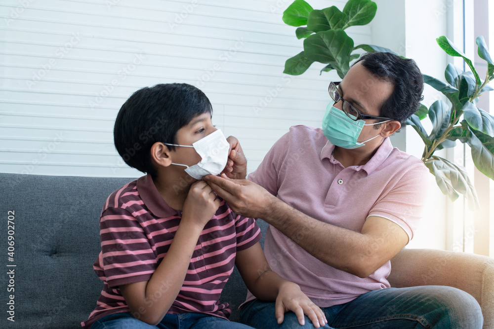 Indian dad helps his son wearing medical mask for protection Covid-19 ...