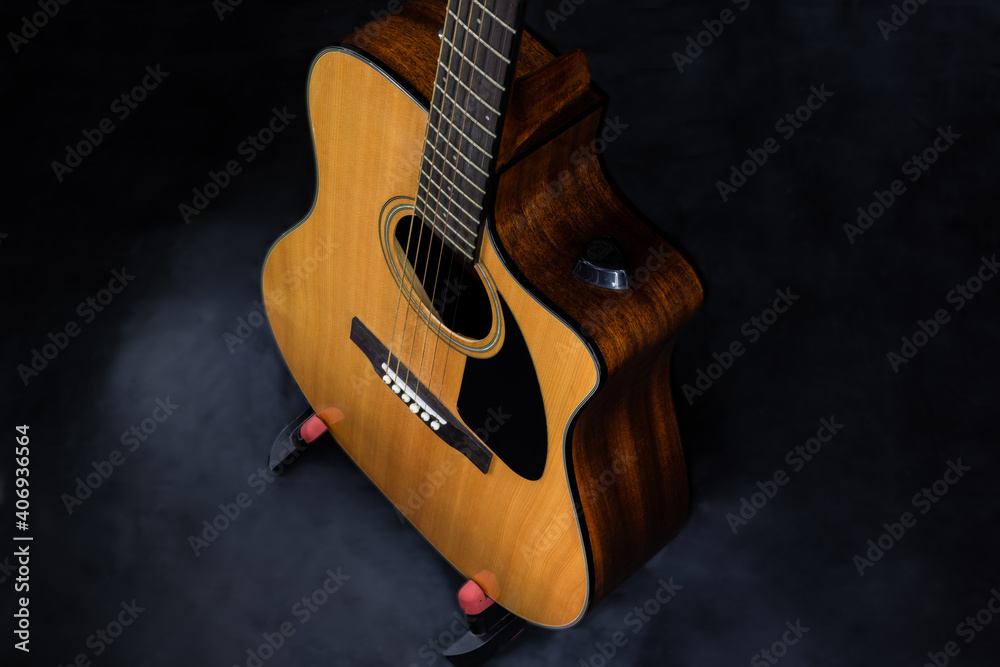 top view on body of classic yellow acoustic guitar with steel strings ...