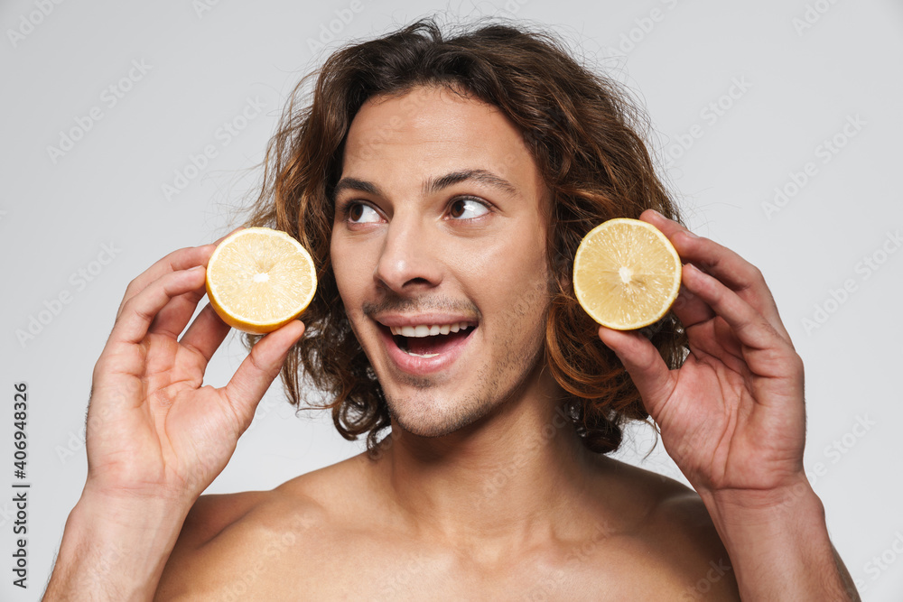 Joyful shirtless guy smiling while posing with lemon Stock Photo ...