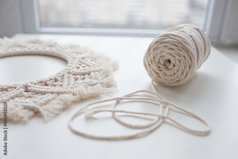 Handmade macrame braiding and cotton threads on white background ...