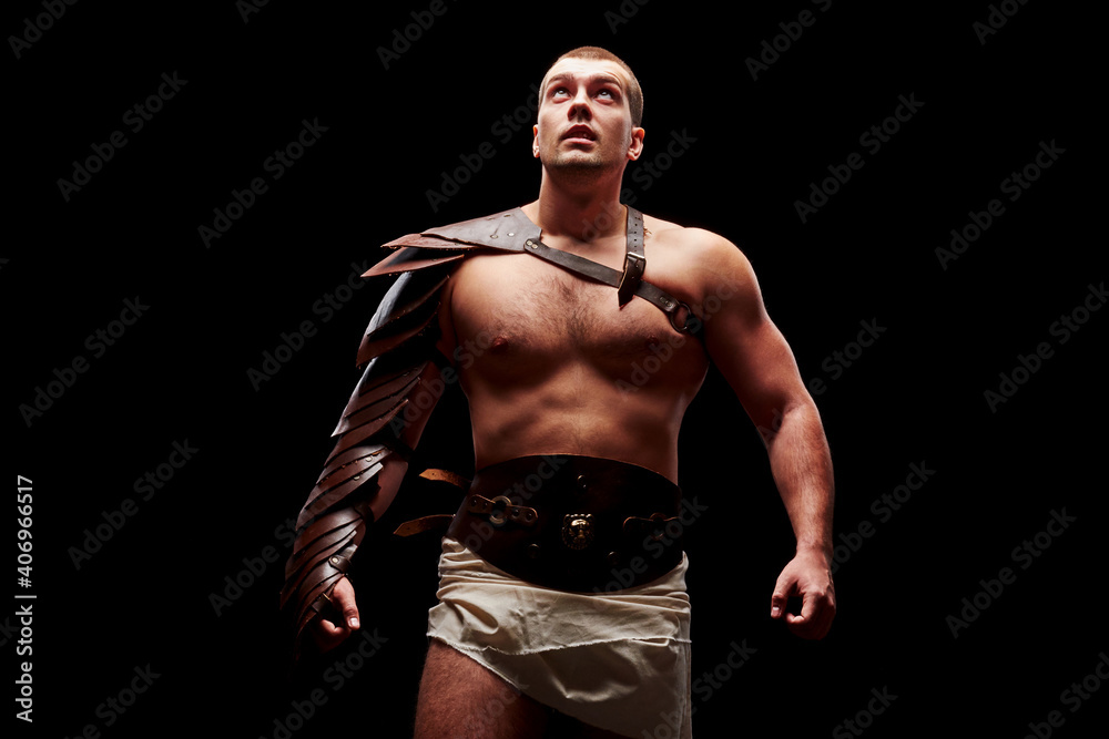 Gladiator with sword and armor on a black background. A warrior in ...