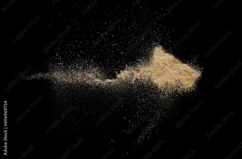 Sand flying explosion on black background ,throwing freeze stop motion ...