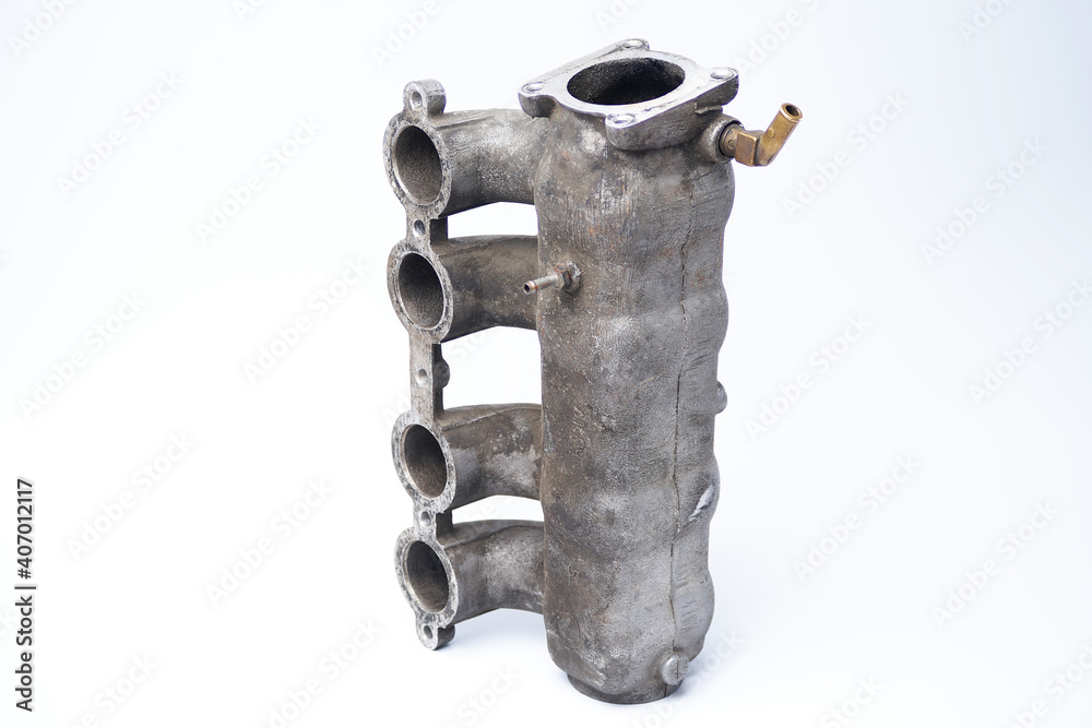 The intake manifold stands upright against a white background. Dirty ...
