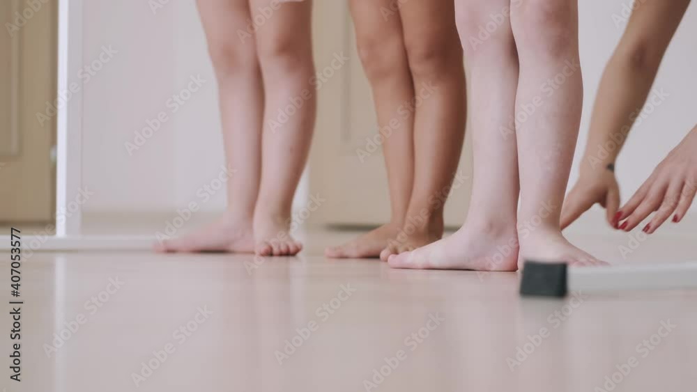 teacher fixes ballet girls feet stand child family baby mother woman ...