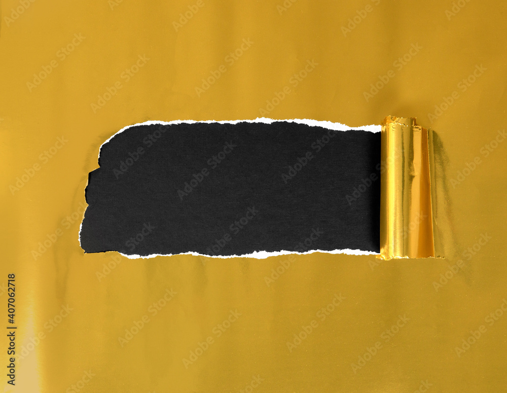 Shiny gold ripped torn paper against black background texture, copy ...