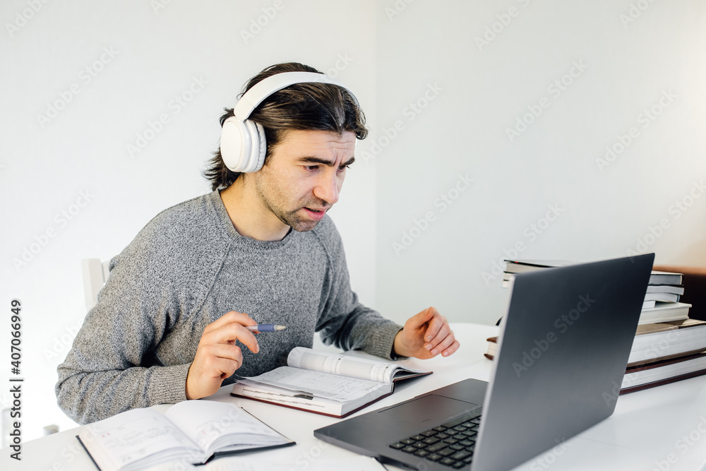 guy student wearing headphones using laptop for distance education ...