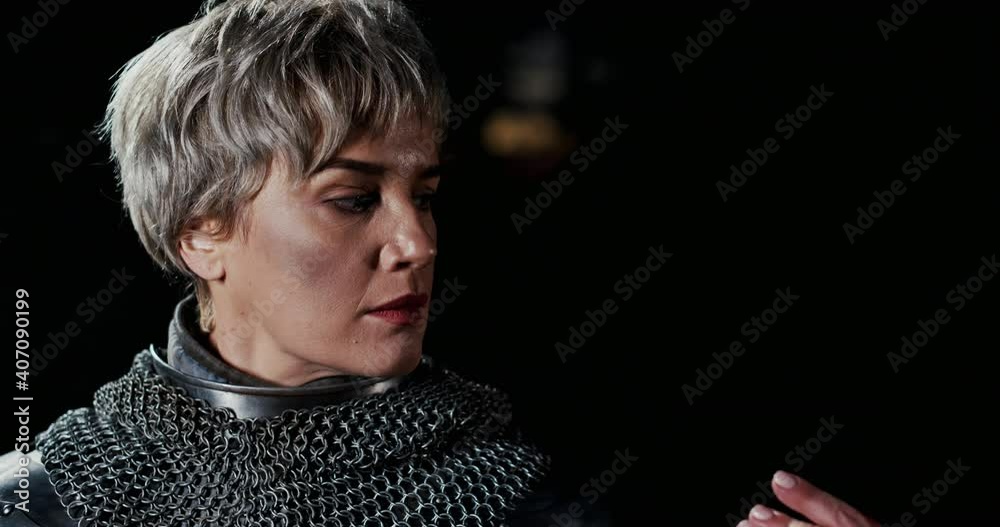 The gaze of a brave and violent female warrior who holds a standing ...