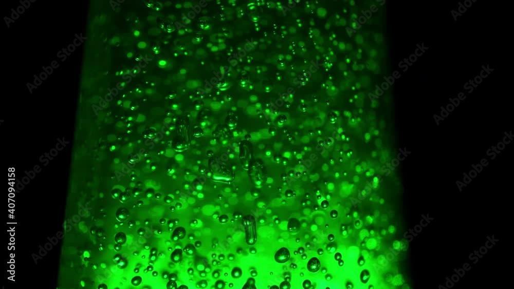 Macro shot of blurred bubbles on illuminating green background. Bubbles ...