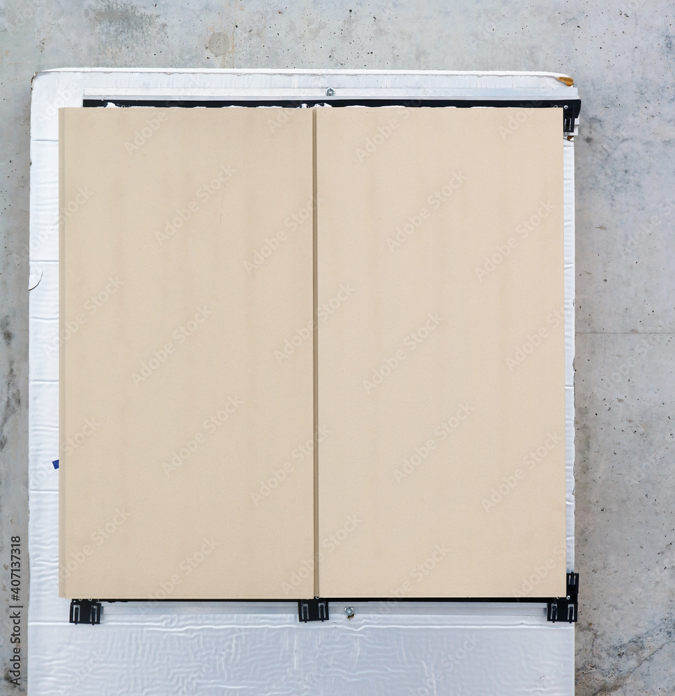 Samples of outdoor stone slabs installed on a gray fresh concrete ...