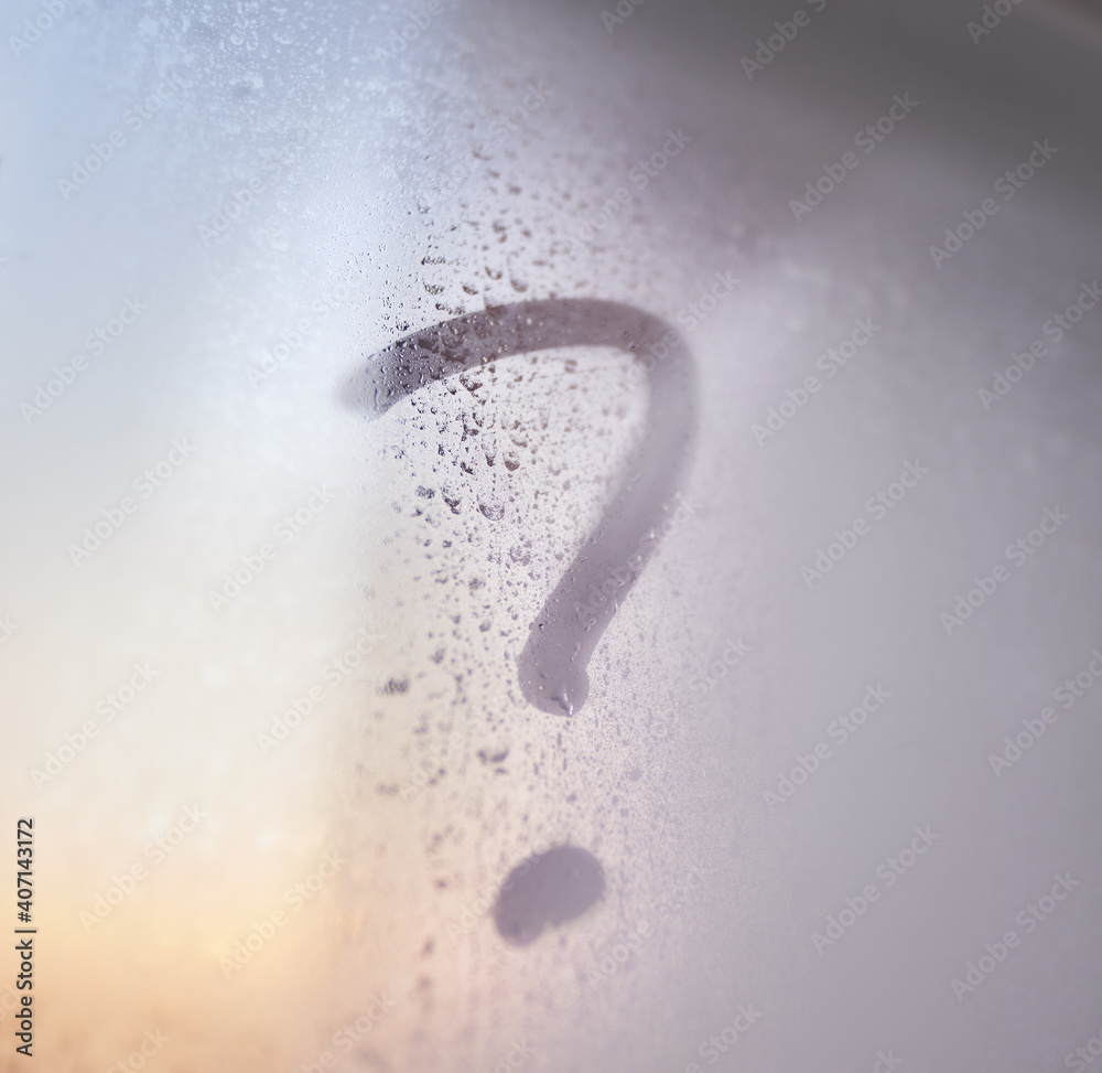 The question mark on the window with water drops on sunny background ...