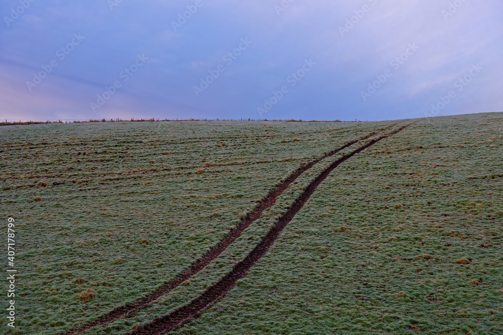 Deep Tracks left by a Farm Tractor cut across the steep slope of a ...