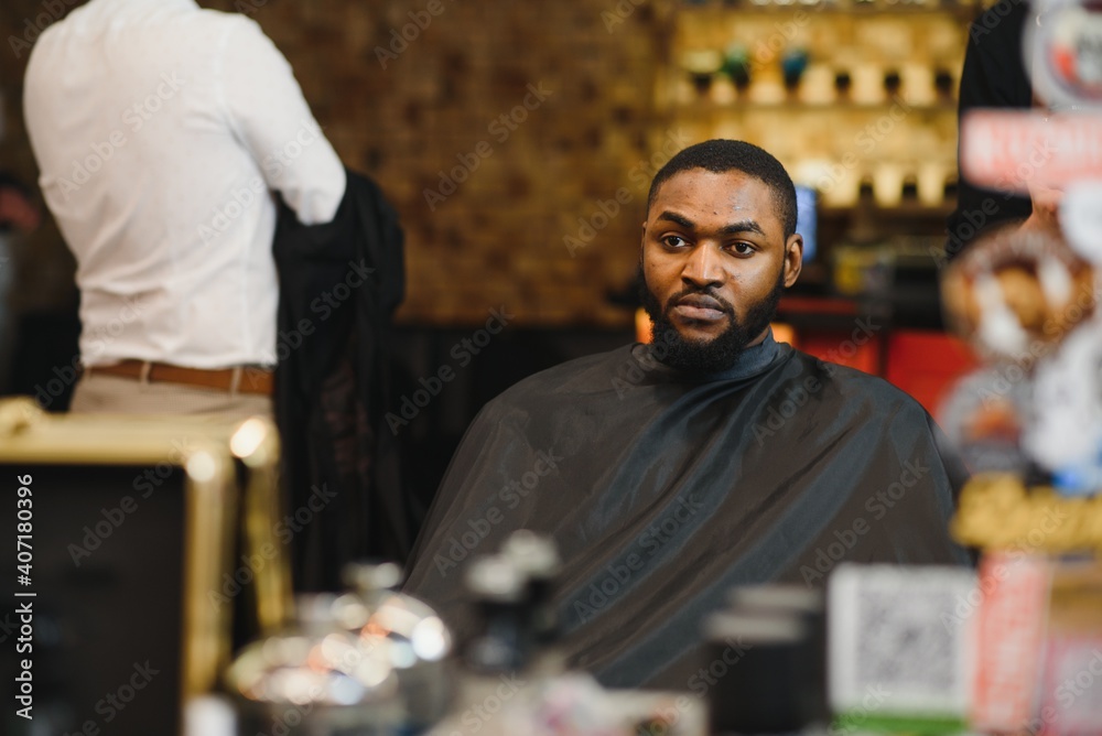 Side view of serious man with stylish modern haircut looking forward in ...