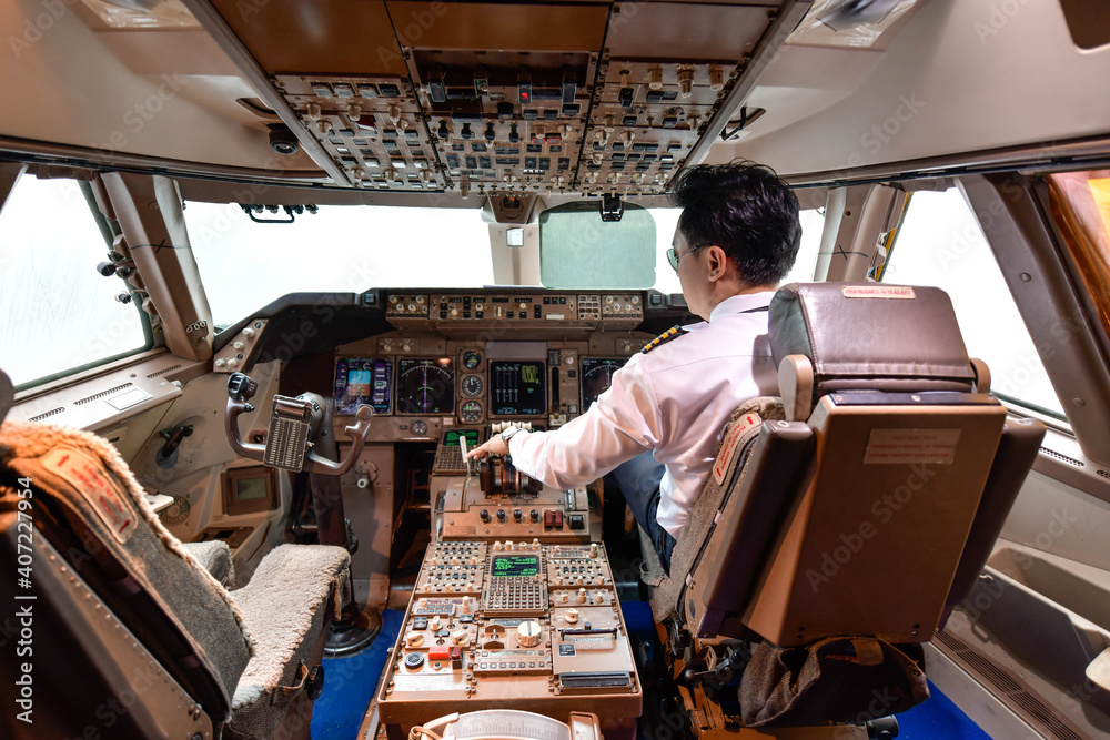 Airline pilot work in the cockpit Stock Photo | Adobe Stock