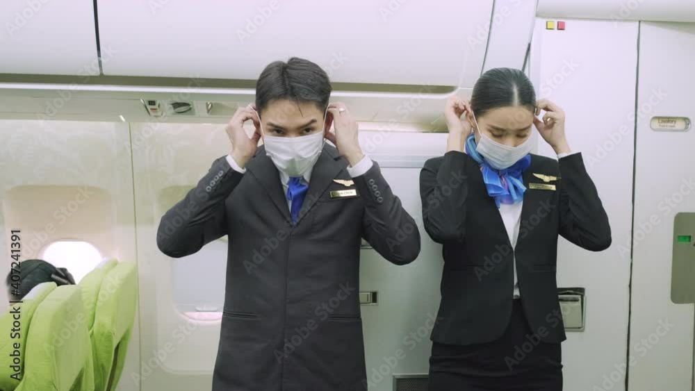 Flight attendance in uniform and show how to wear protective hygiene ...
