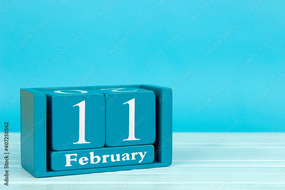 wooden calendar with the date of February 11 on a blue wooden ...