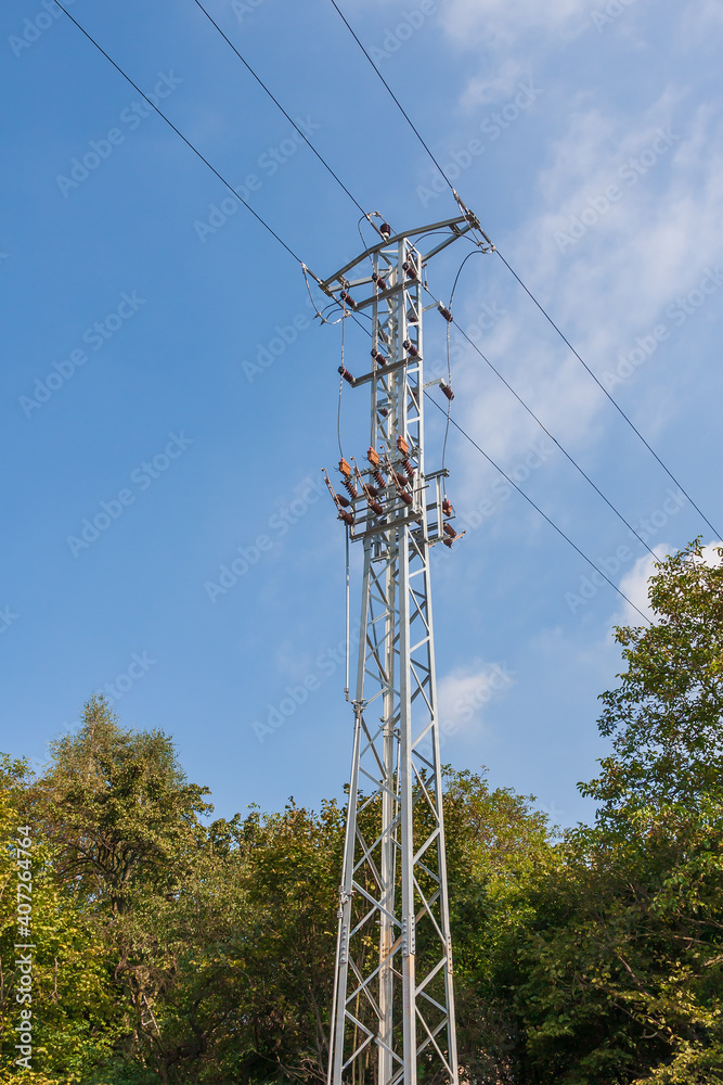 High metal mast of high voltage in nature. Electrical wires run across ...
