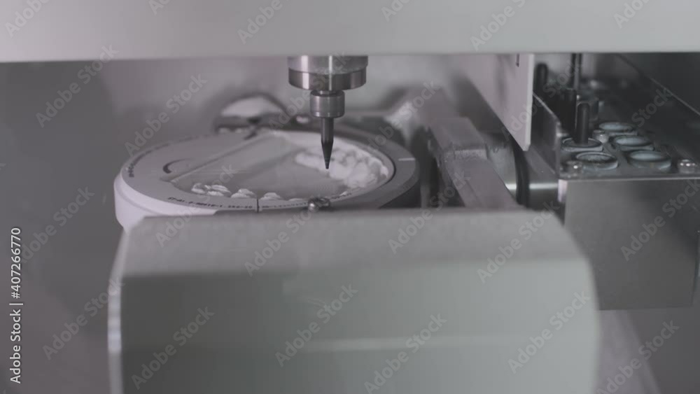 A professional CNC machine automatically creates a tooth prosthesis ...