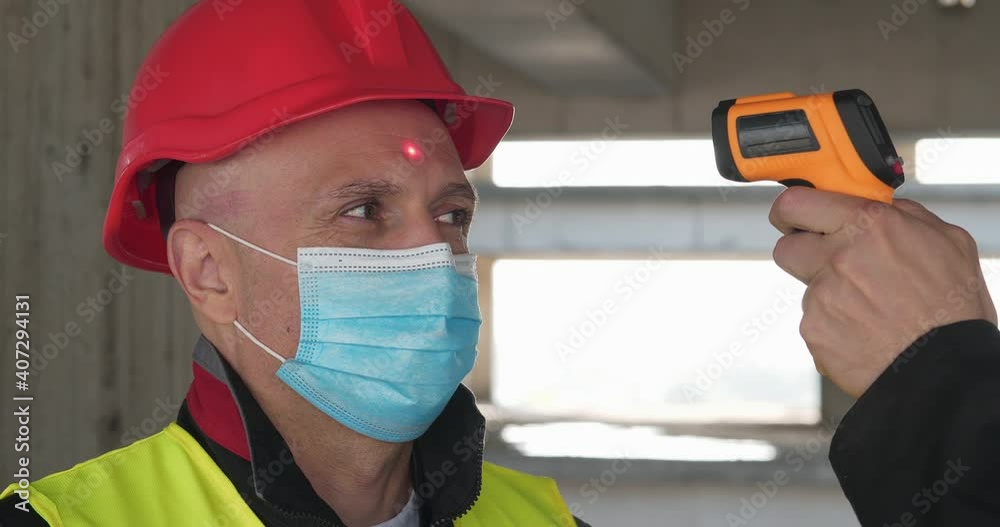 Slow Motion Handcuffed construction worker in red hard hat and medical ...