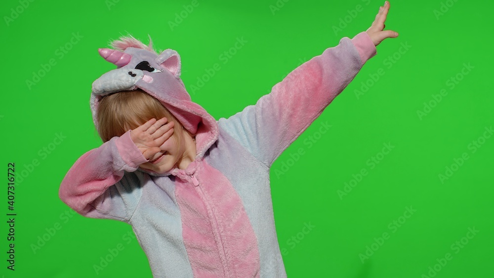 Child smiling, dancing, celebrating, performing dab dance in unicorn ...