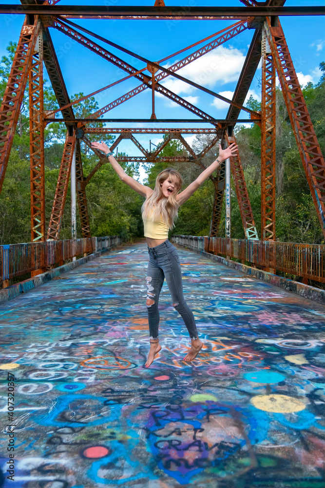 Young Blonde Teenage Girl on an Abandoned Graffiti Bridge Stock Photo ...