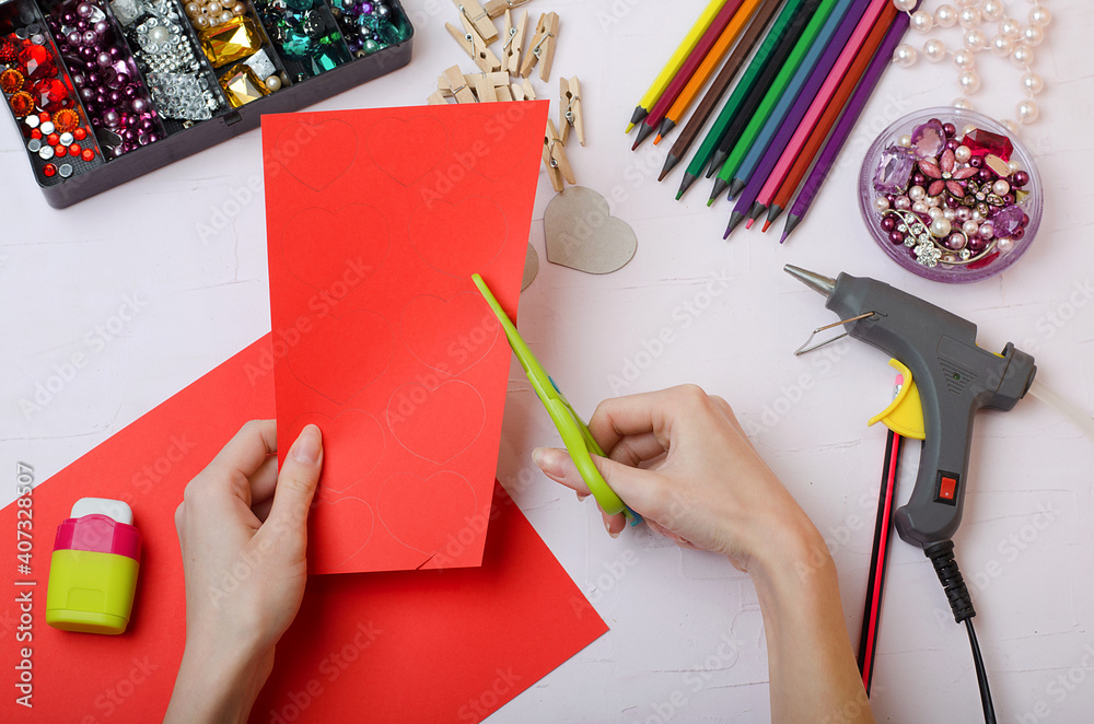 Women's hands do the craft.On a light background, colored pencils ...