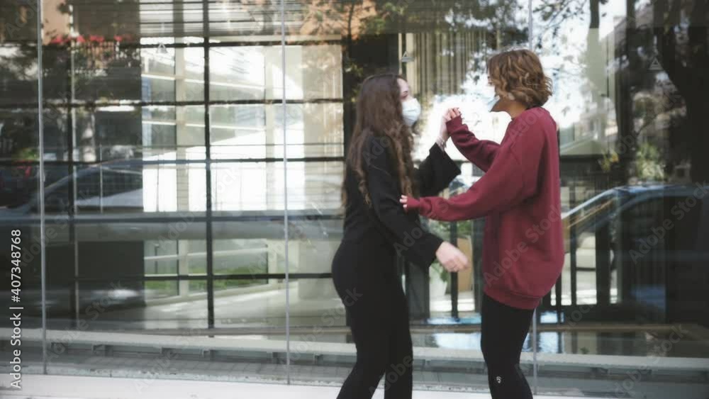 social distancing - two girls who are about to hug each other touch ...