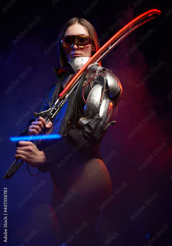 Atmospheric portrait of a beautiful female assassin posing in dark ...