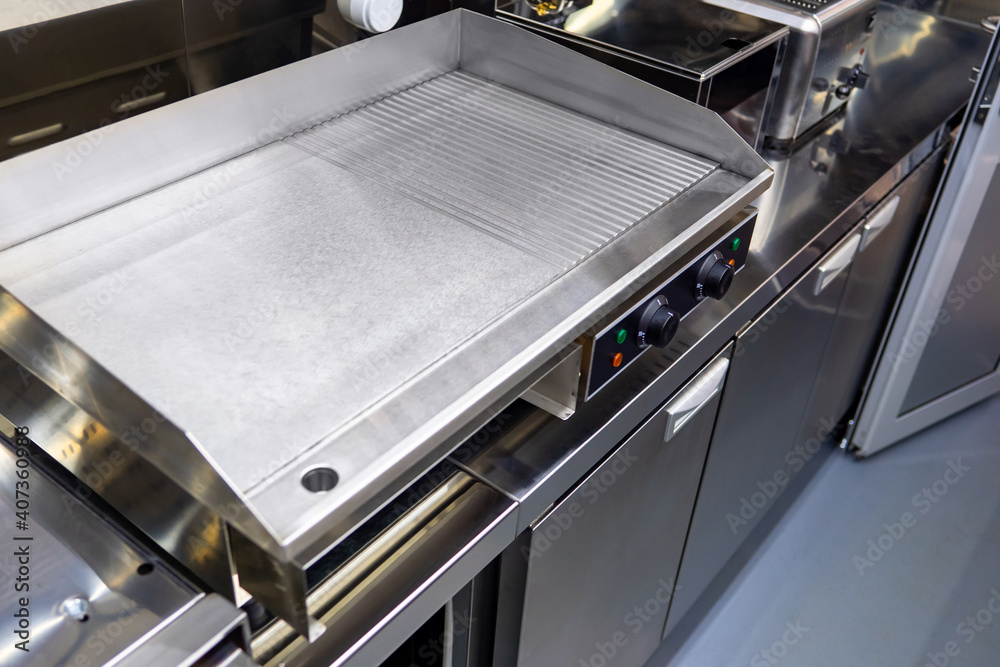 Electric industrial frying pan. Frying surface in a restaurant. New ...