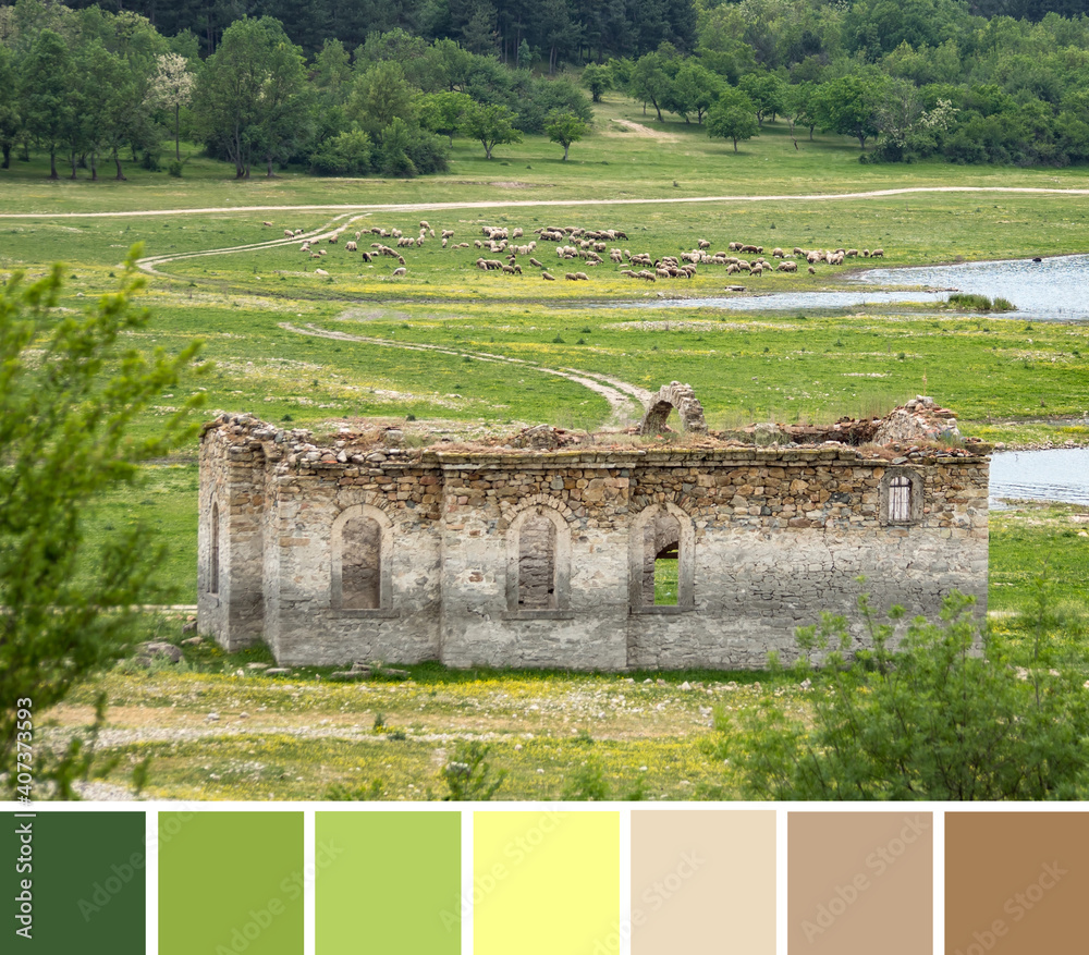 Spring green landscape with ruins of abandoned stone building in beige ...