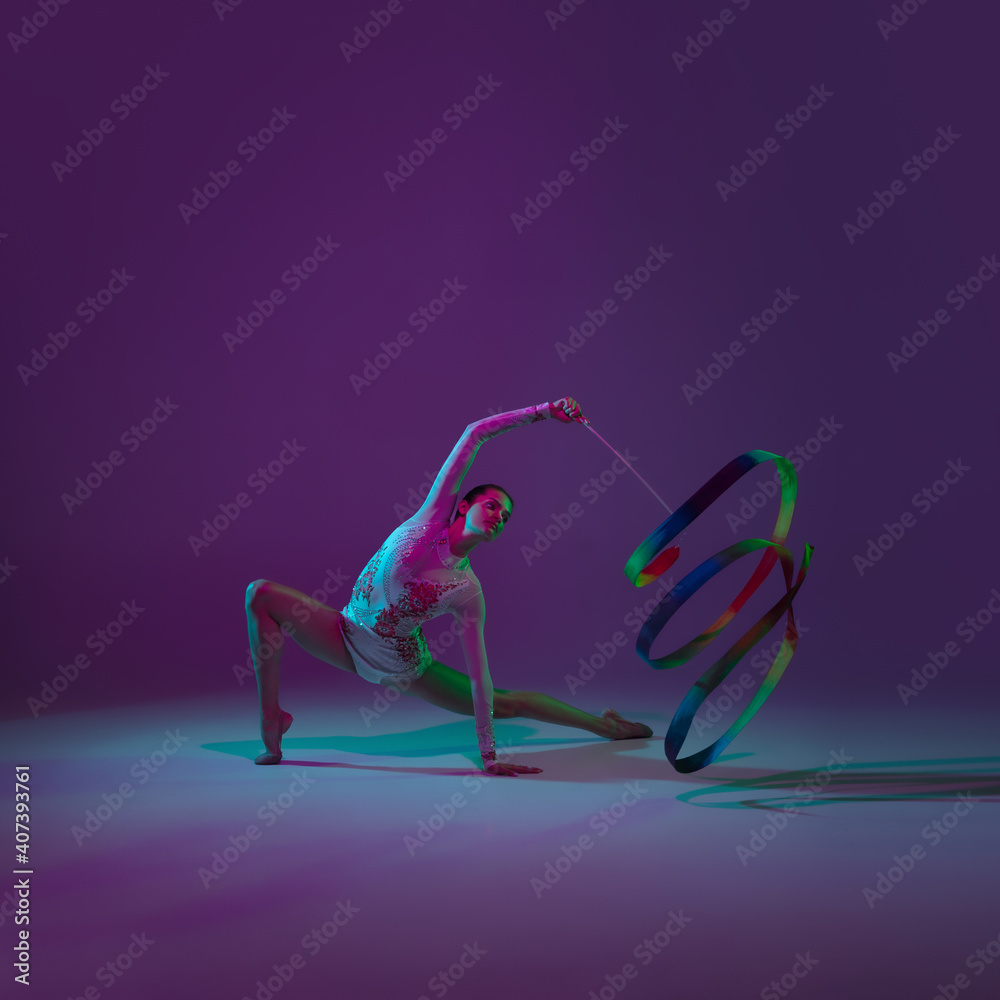 Rainbow. Young female athlete, rhythmic gymnastics artist dancing ...