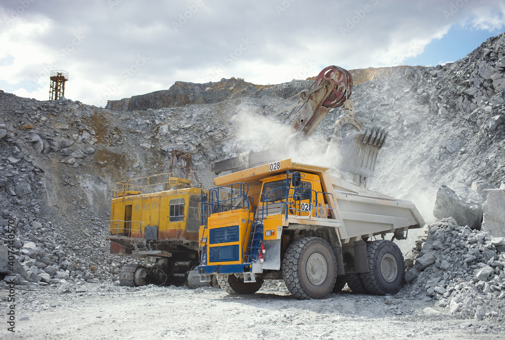 Heavy mining dump truck at the time of loading the large stone ...